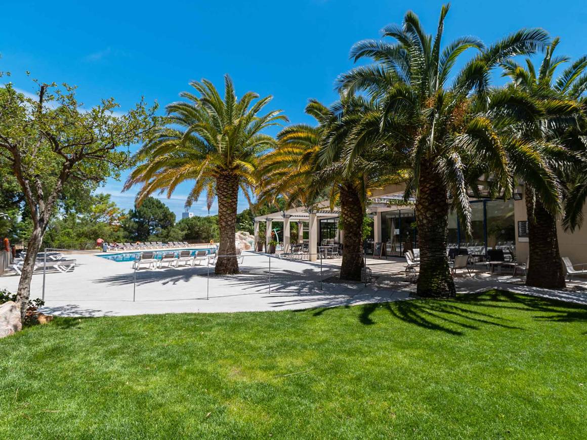Swimming pool and Mediterranean beach at the camping Sant Pol