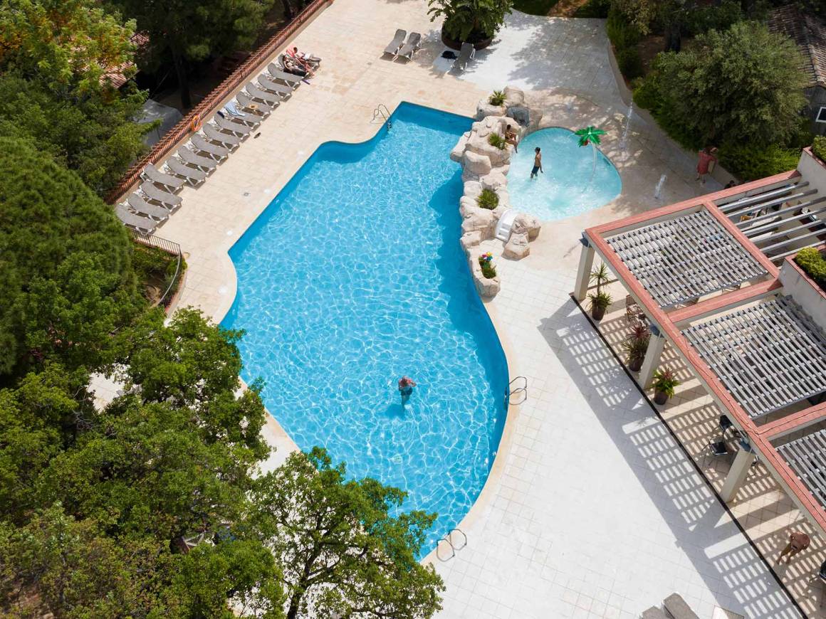 Swimming pool and Mediterranean beach at the camping Sant Pol